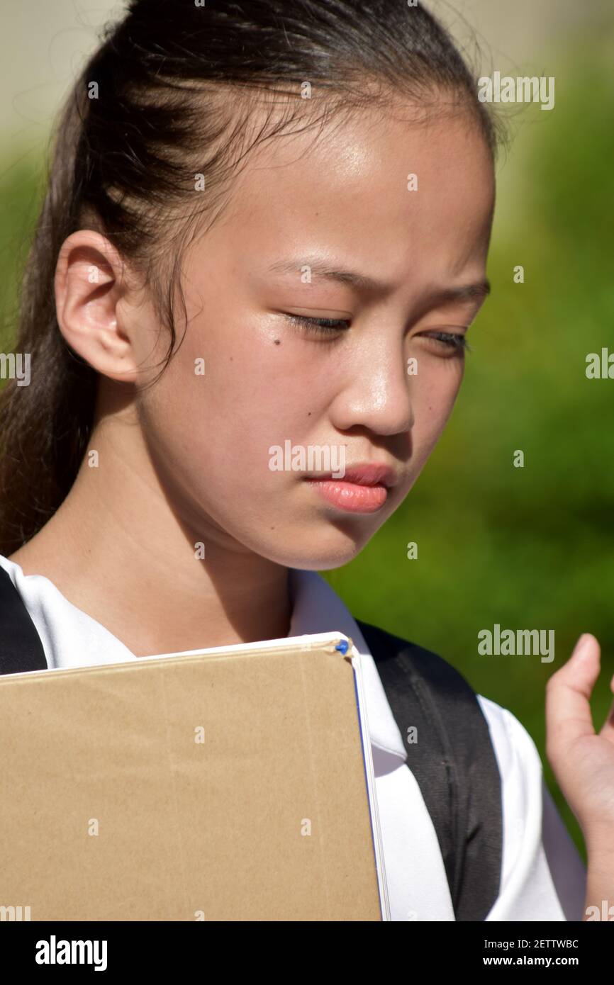Unhappy Pretty Filipina Female Student With Books Stock Photo - Alamy
