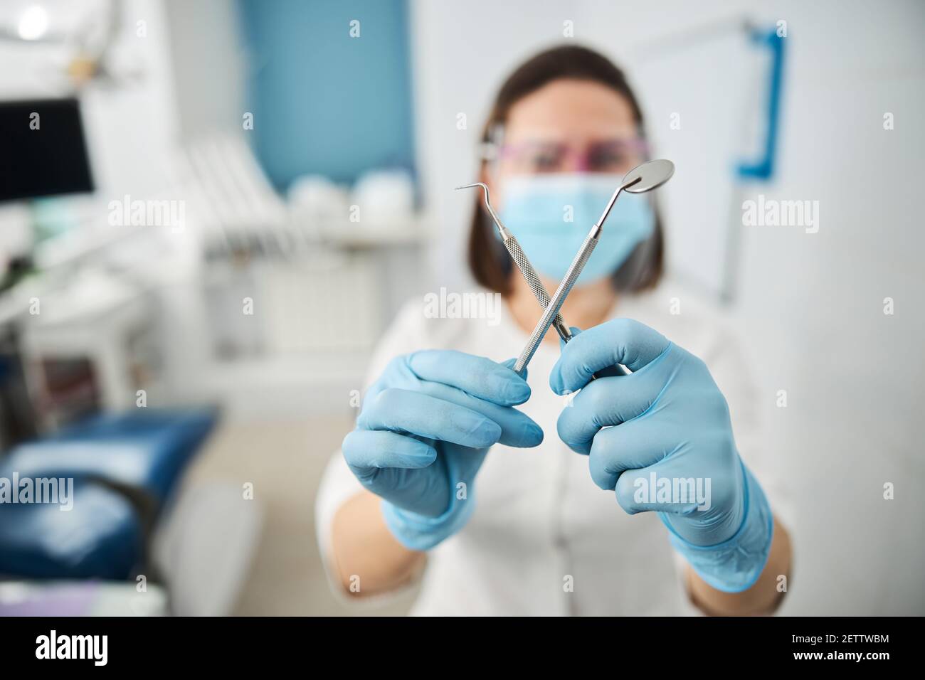 Medical worker showing dental mirror and probe across each other Stock ...