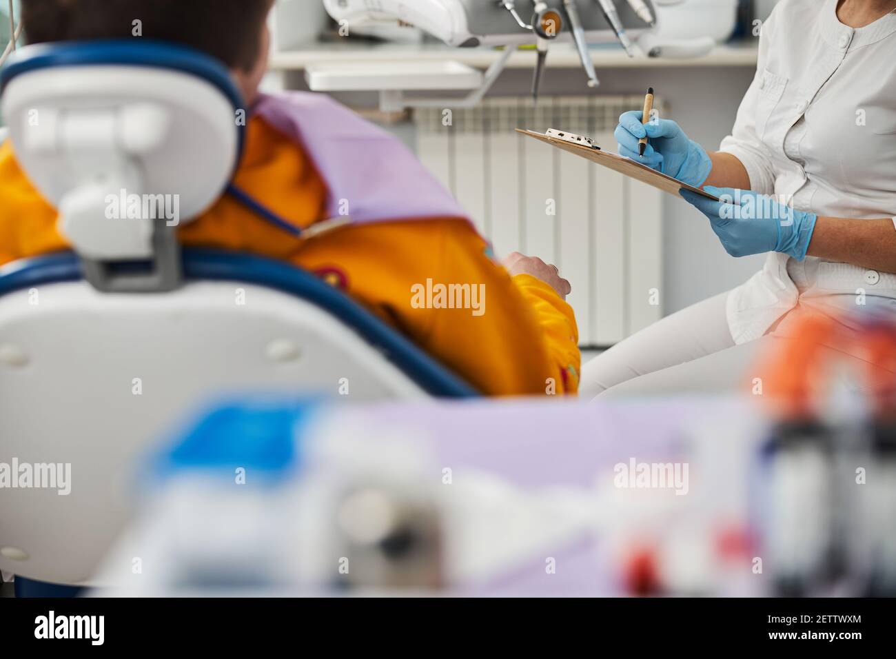 Adult making a record of male words on clipboard page Stock Photo - Alamy