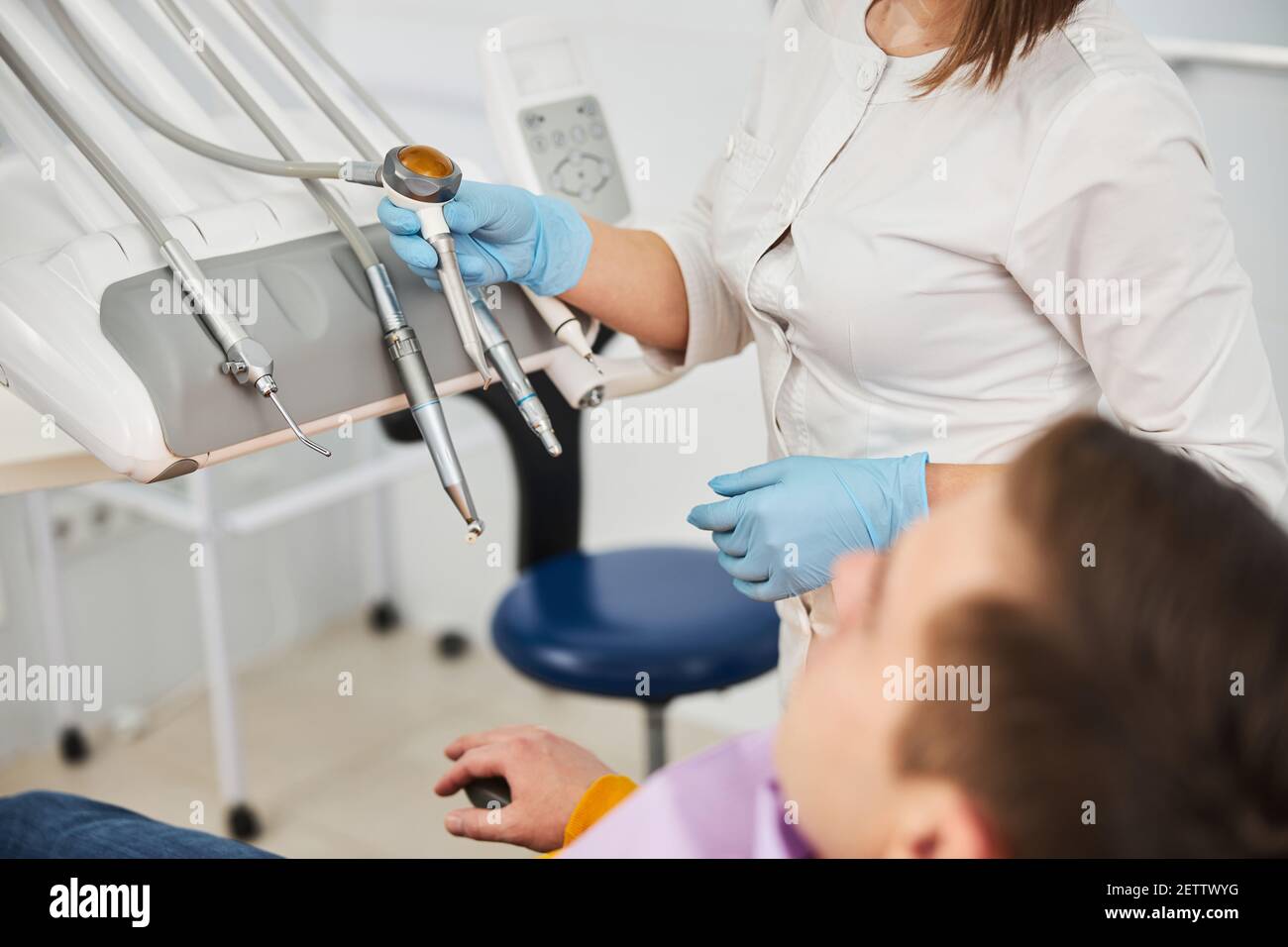 Dental professional lifting tooth surface whitening and polishing ...