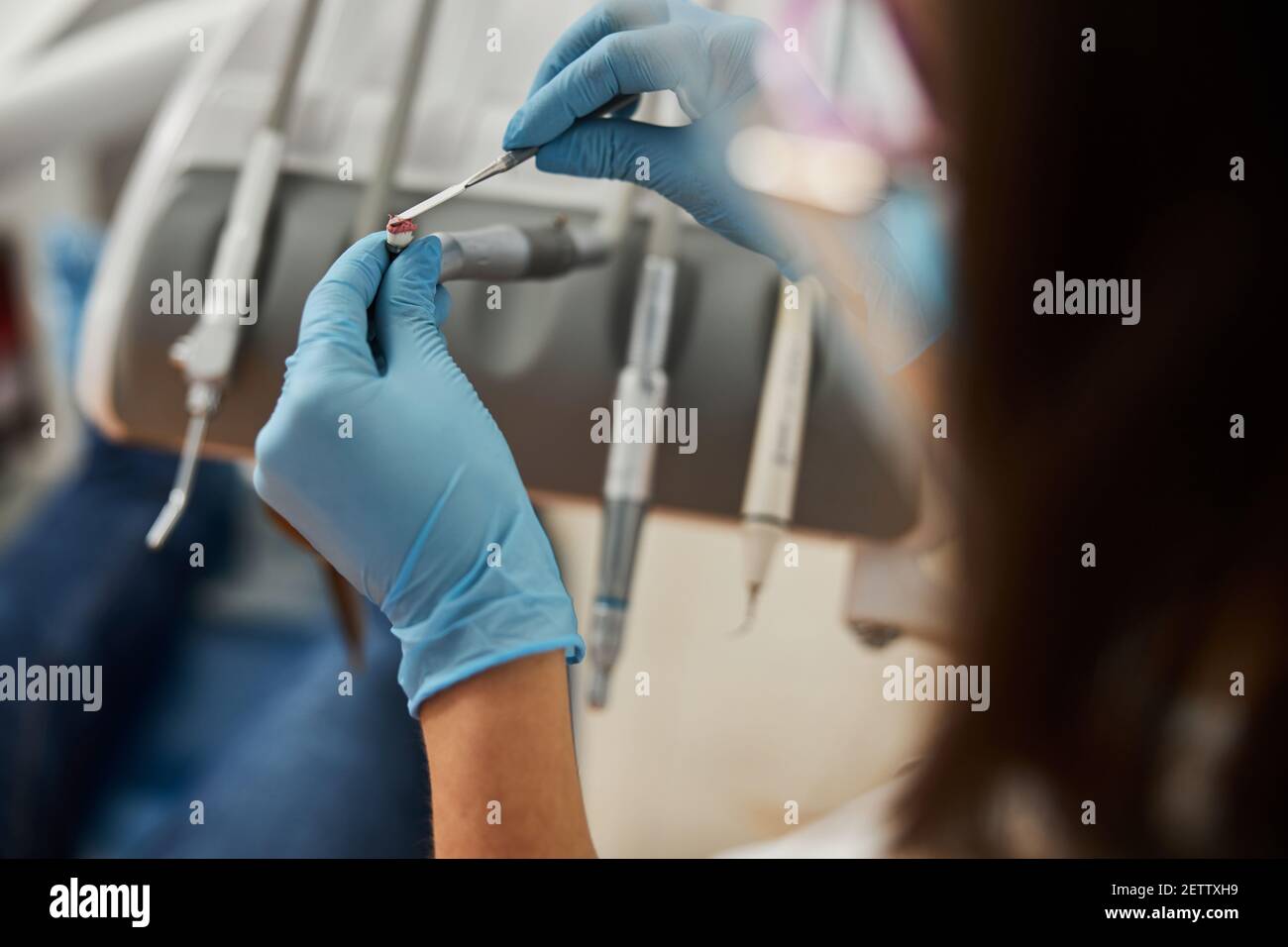 Dentist smearing prophy paste on handpiece with dental instrument Stock ...