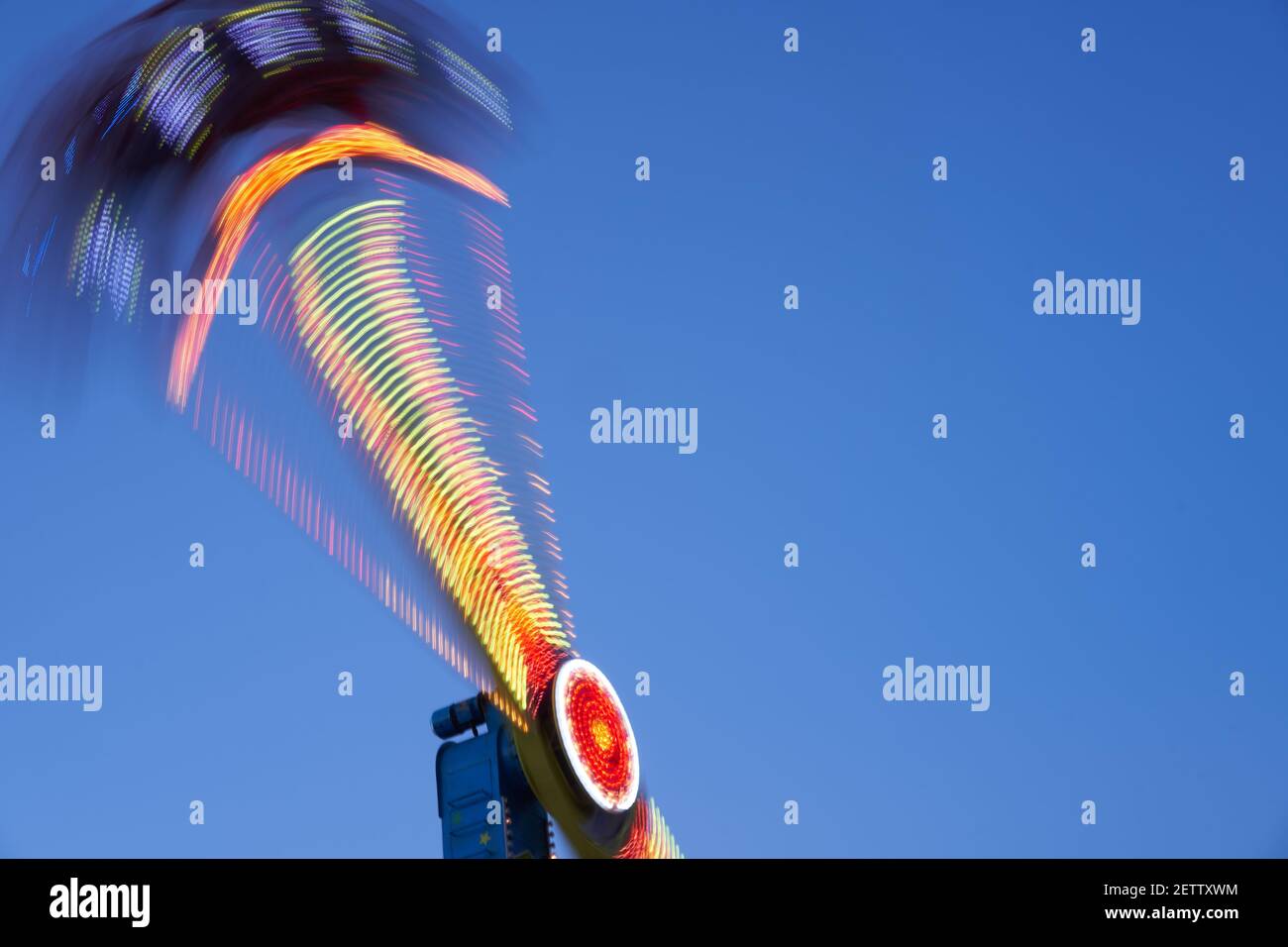Amusement park blurred effect. Abstract illuminated background Spinning ...
