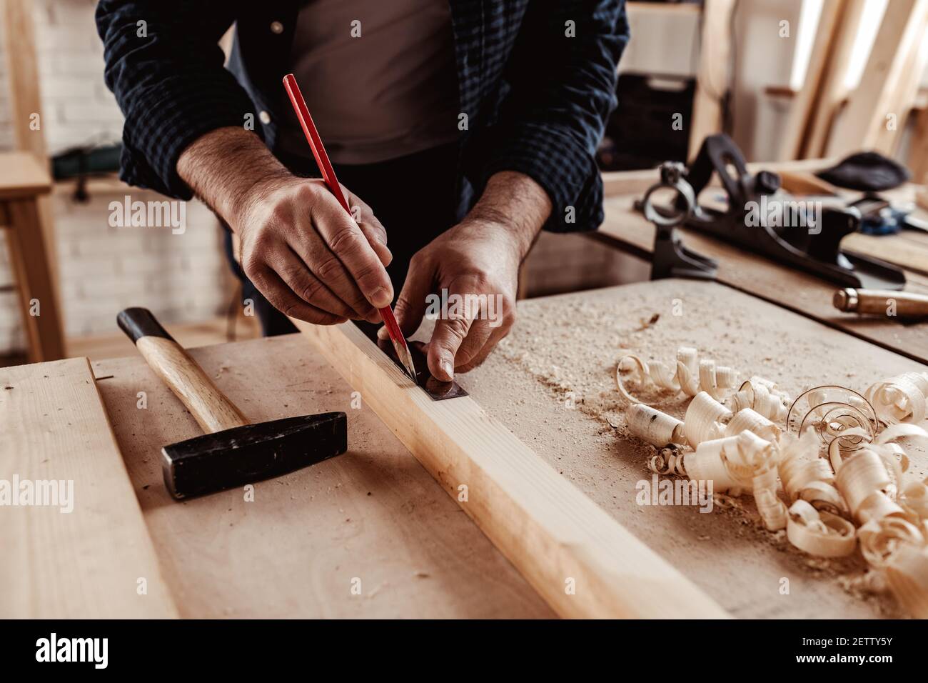 Carpenter makes pencil marks on a wood plank Stock Photo - Alamy
