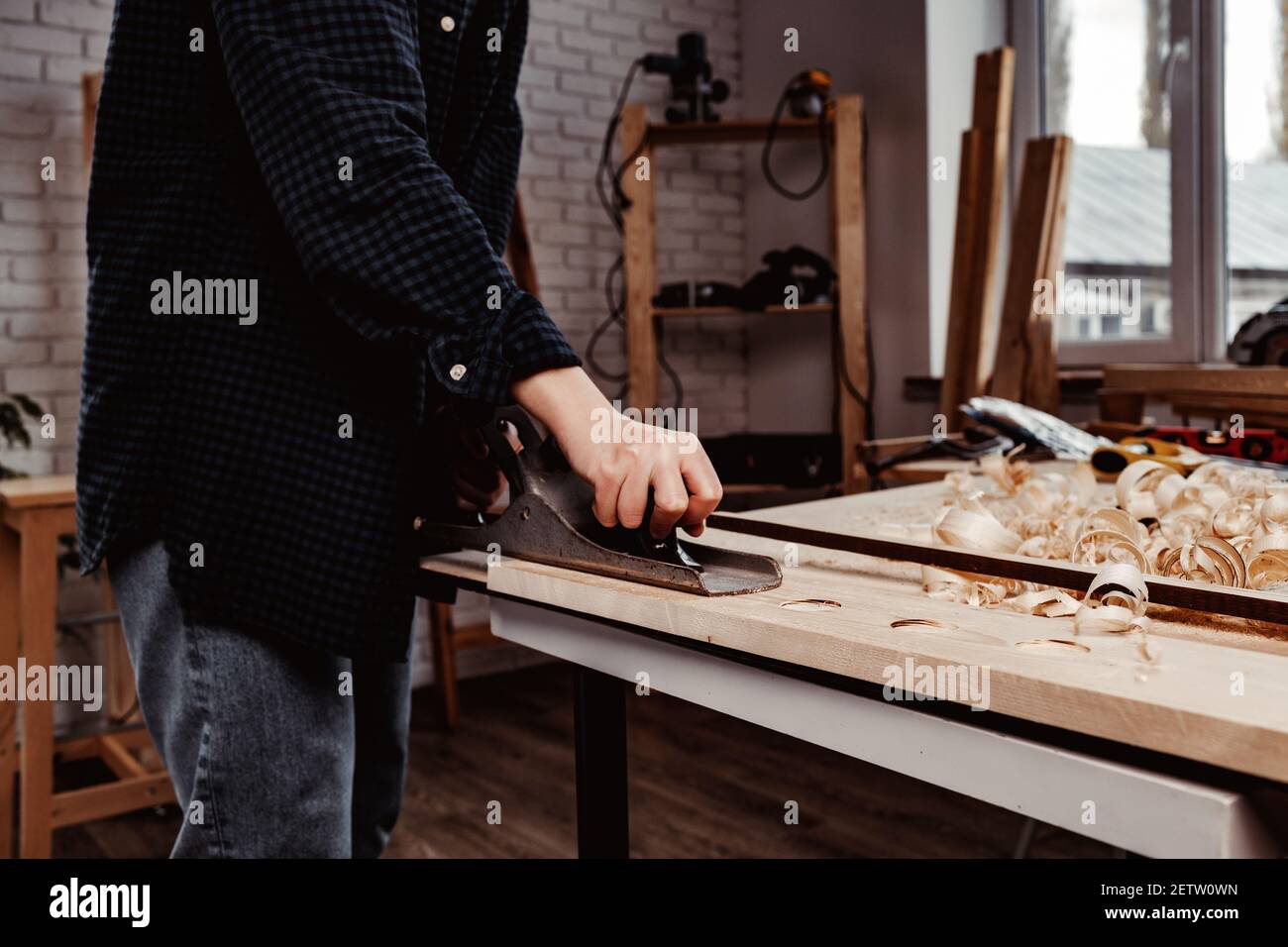 Carpenter's hands planing a plank of wood with a hand plane Stock Photo ...