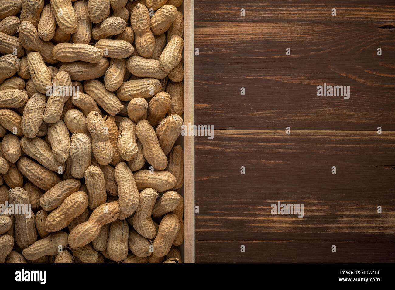 Peanut in a shell on wooden background. Food background. Top view Stock ...