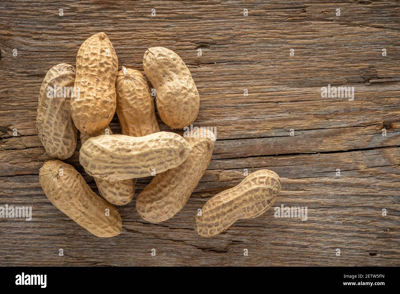 Peanut in a shell on wooden background. Food background. Top view Stock ...