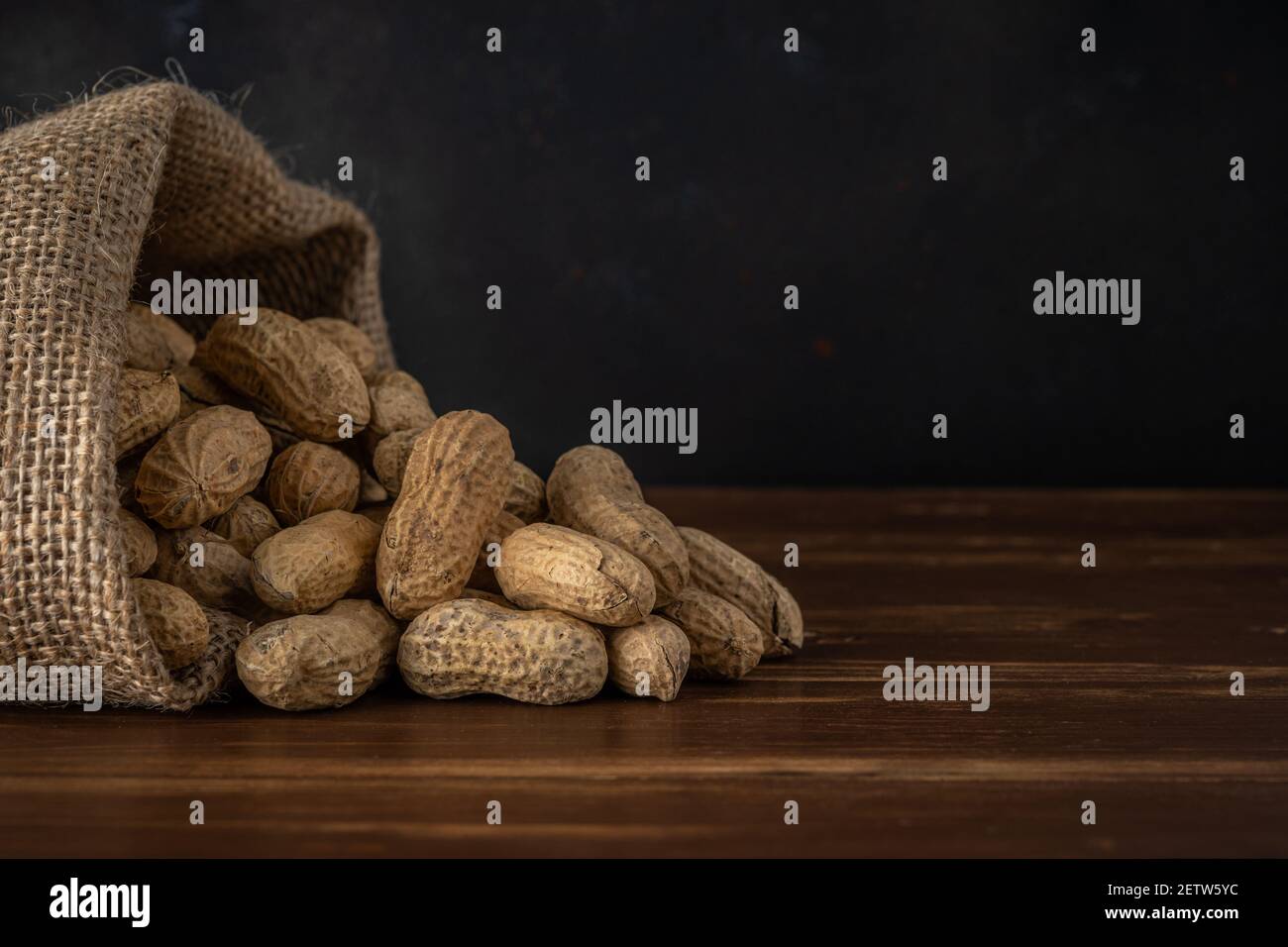 Peanut in sack bag on wooden background. Food background Stock Photo ...