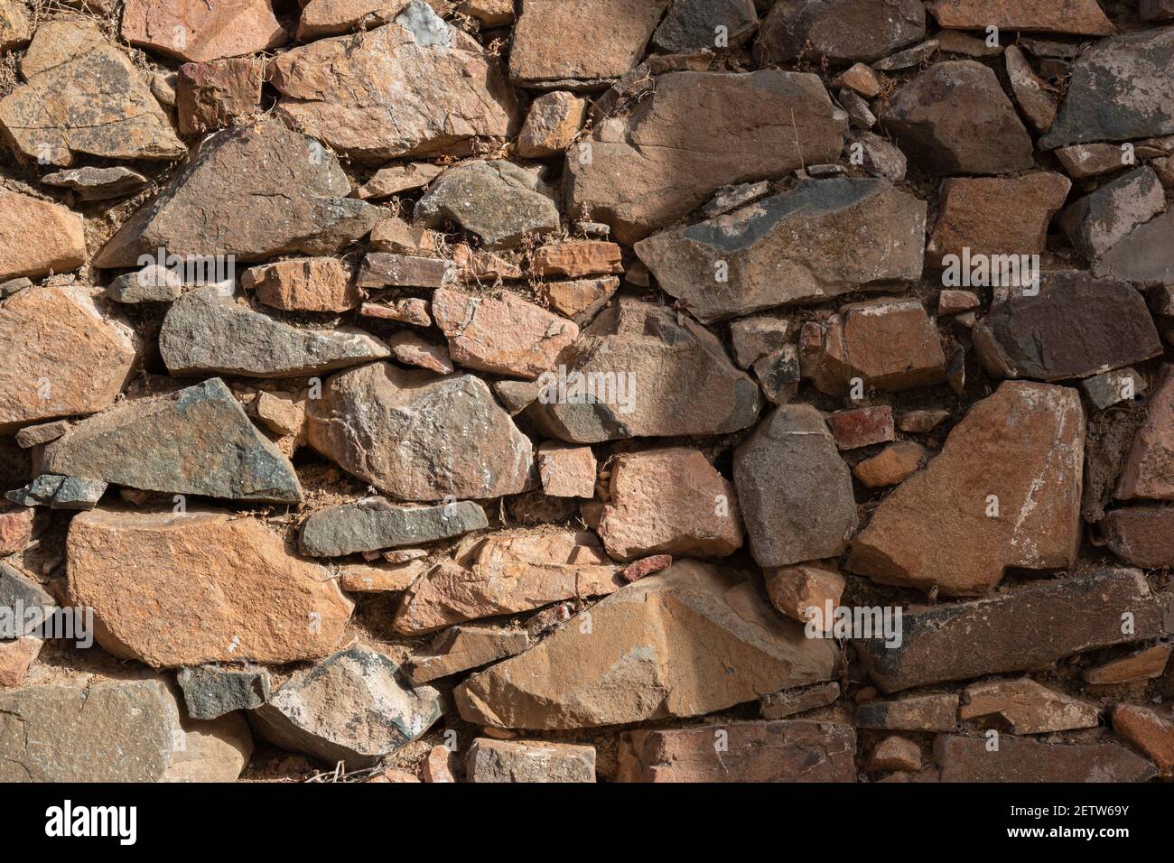 Stone wall of an old house in a village in southern Andalusia in Spain ...