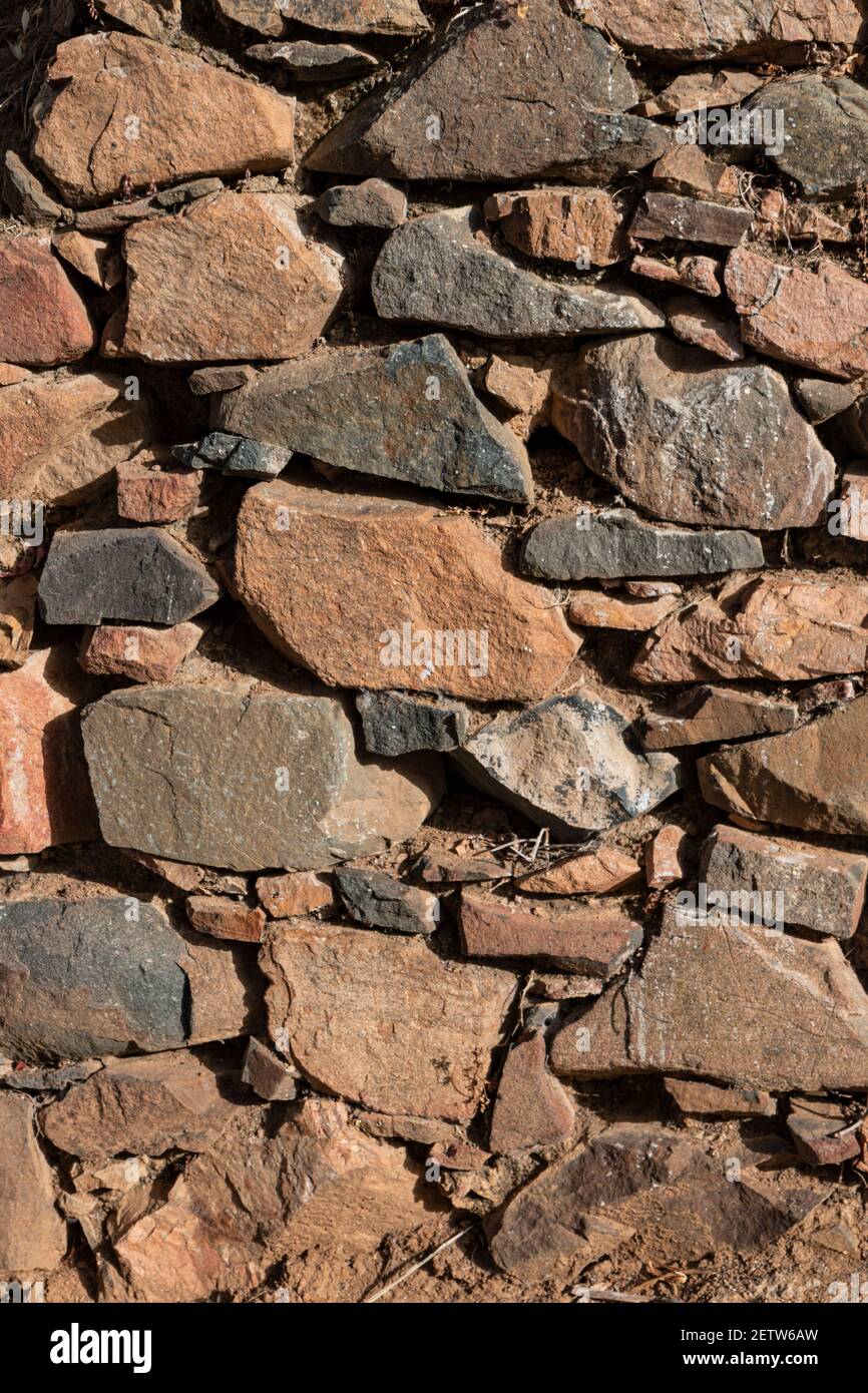 Stone wall of an old house in a village in southern Andalusia in Spain ...