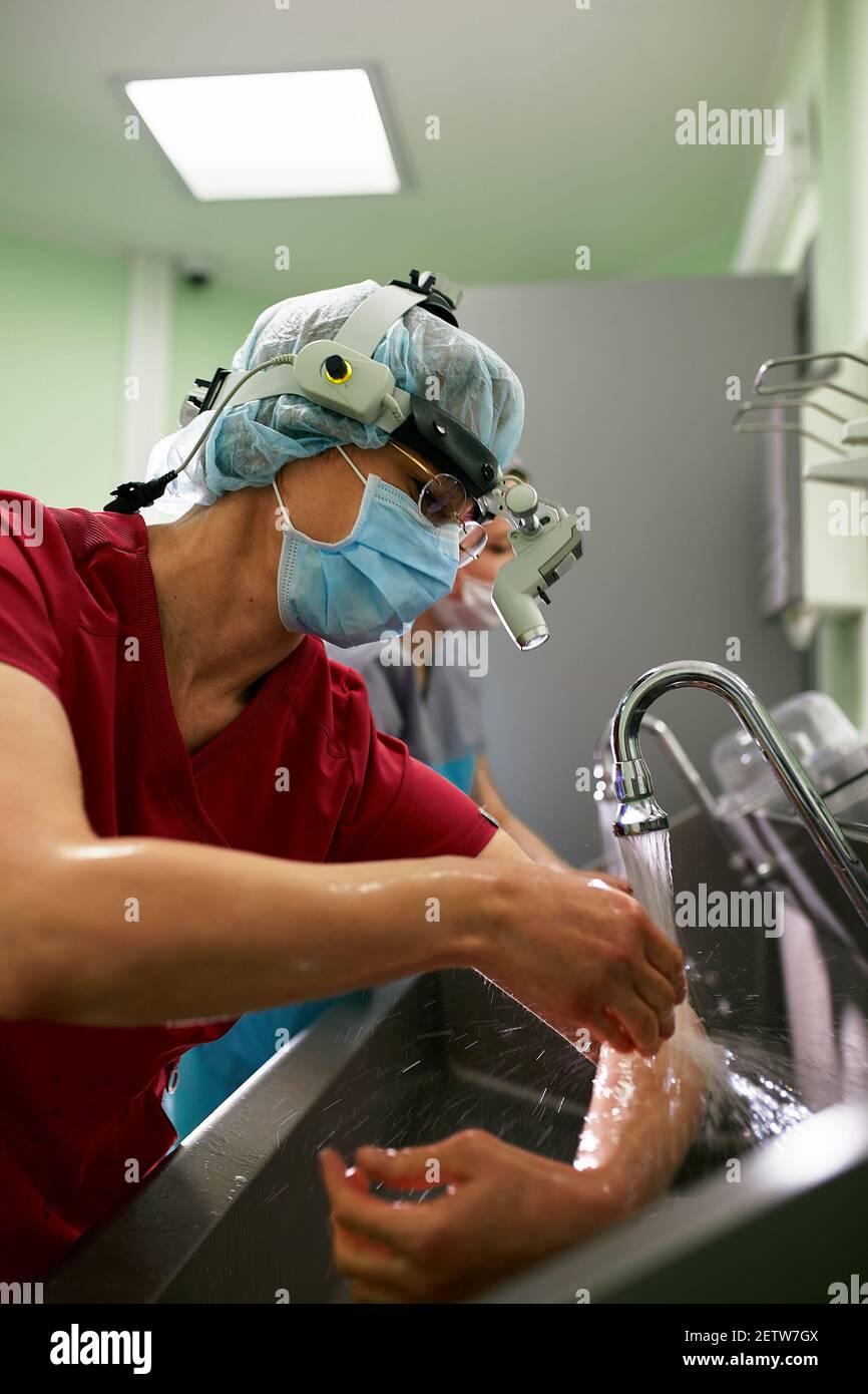 Doctor washes hands, disinfects hands before surgery in preparation ...
