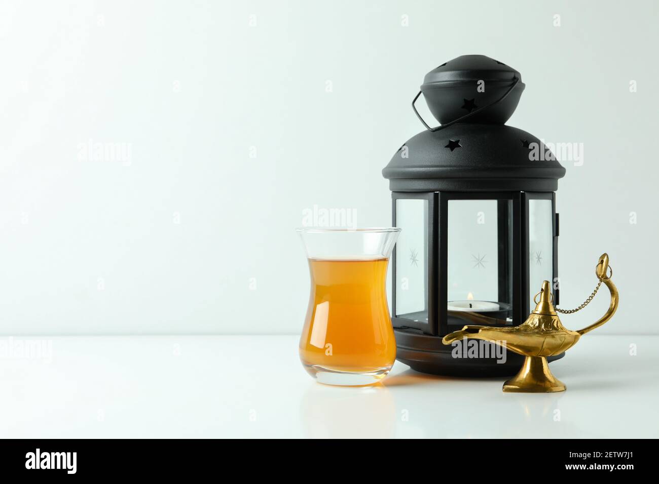 Glass of tea, Ramadan lamp and lantern on white background Stock Photo ...