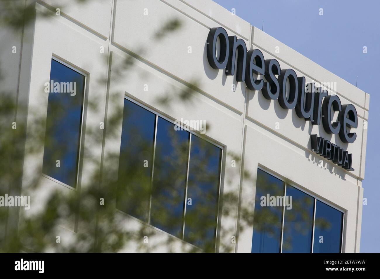 A logo sign outside of a facility occupied by OneSource Virtual in ...