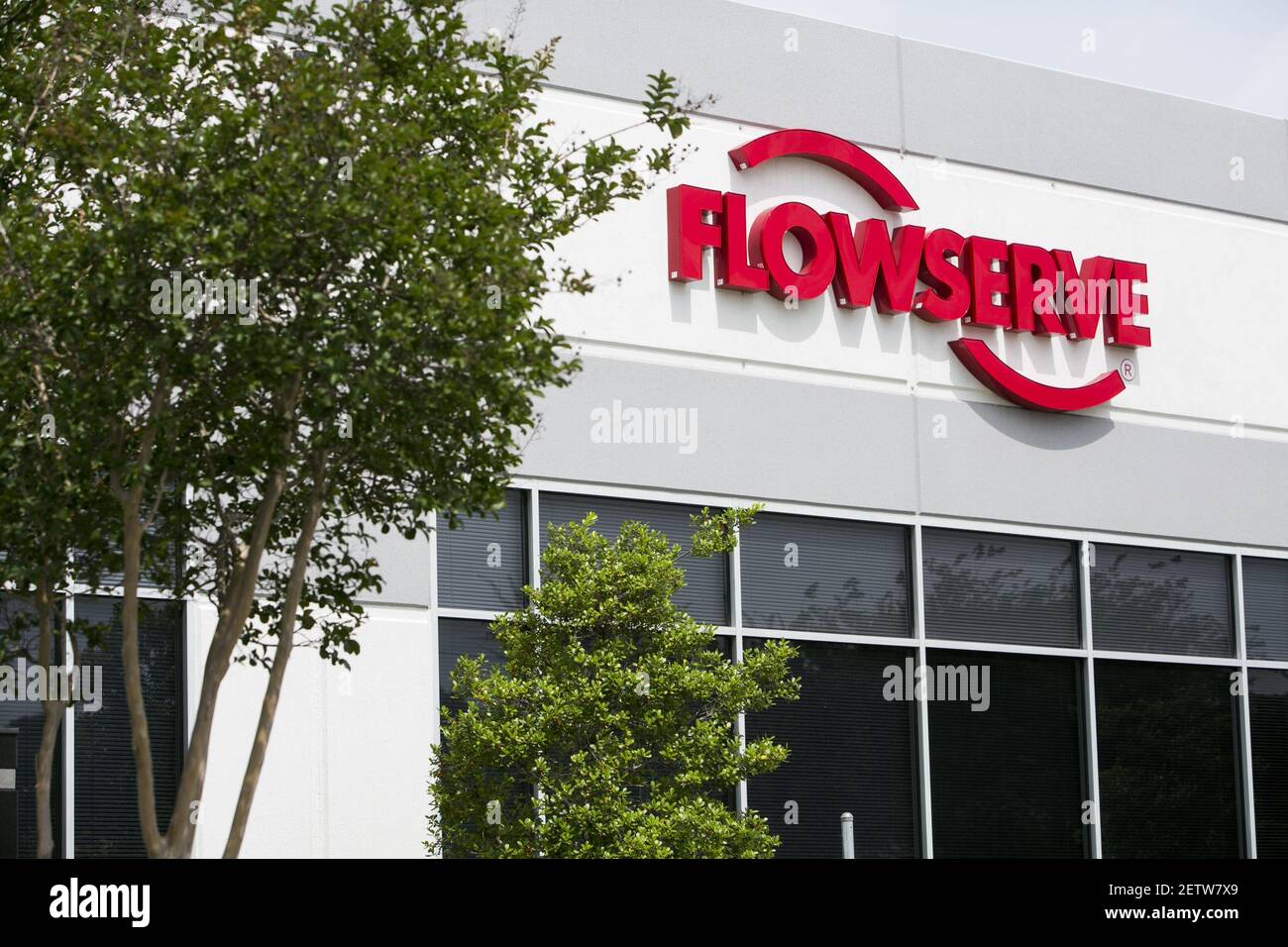 A logo sign outside of a facility occupied by the Flowserve Corporation ...