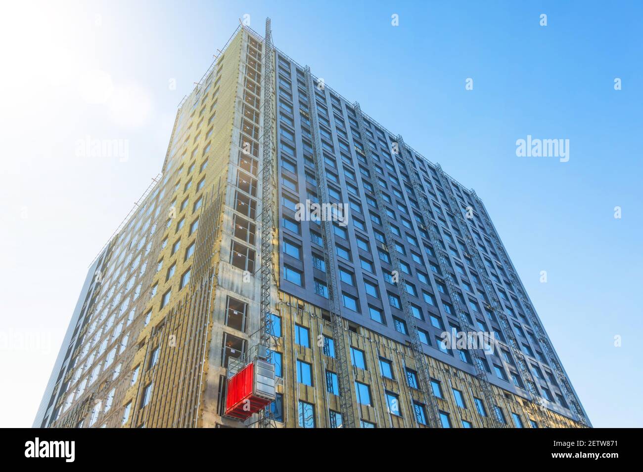 Construction elevator outside the facade of a multi storey building ...