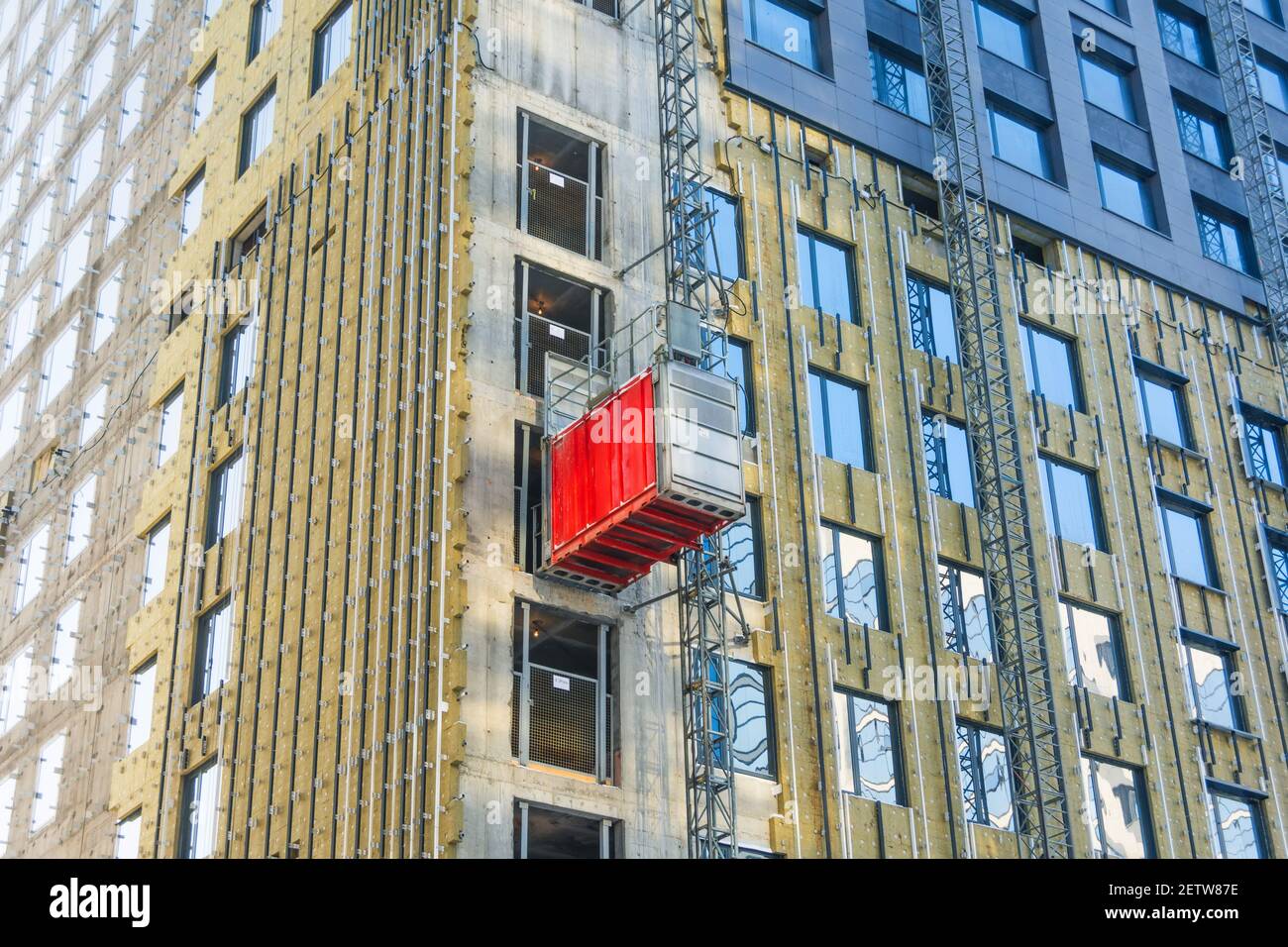 Construction elevator outside the facade of a multi-storey building ...