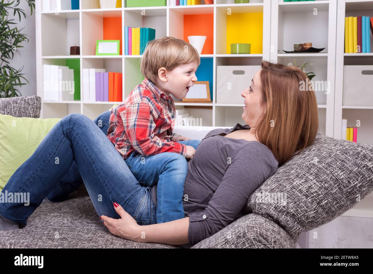 Little boy telling a story to mother Stock Photo - Alamy