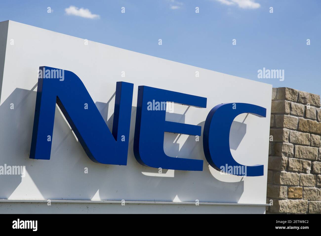 A logo sign outside of a facility occupied by the NEC Corporation in ...