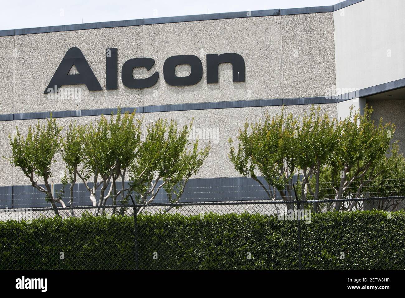 A logo sign outside of a facility occupied by Alcon in Fort Worth ...