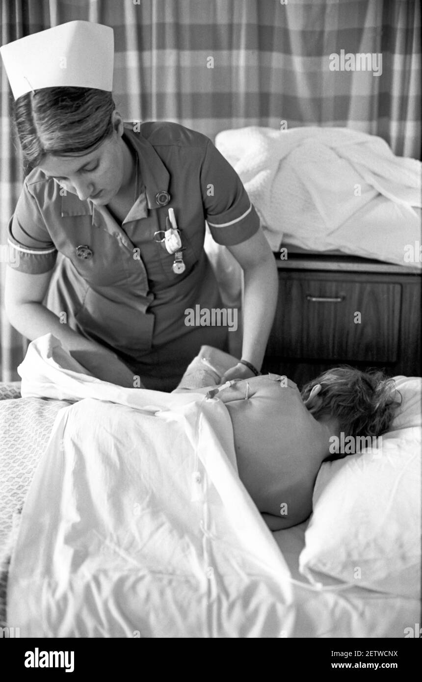 Childrens Ward Cardiff Hospital. Nurse treating Child after surgery ...