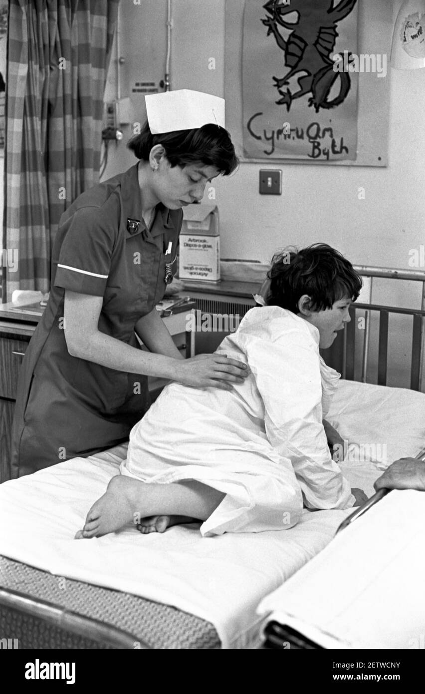 Childrens Ward Cardiff Hospital. Nurse treating child after surgery ...