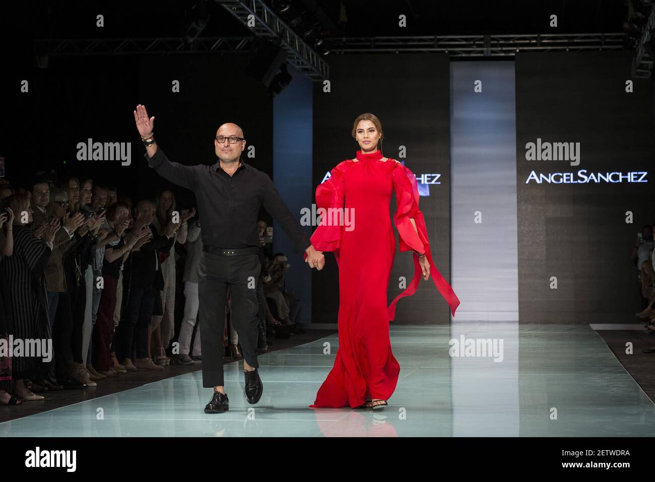 Fashion designer Angel Sanchez greets the crowd after his show on the ...