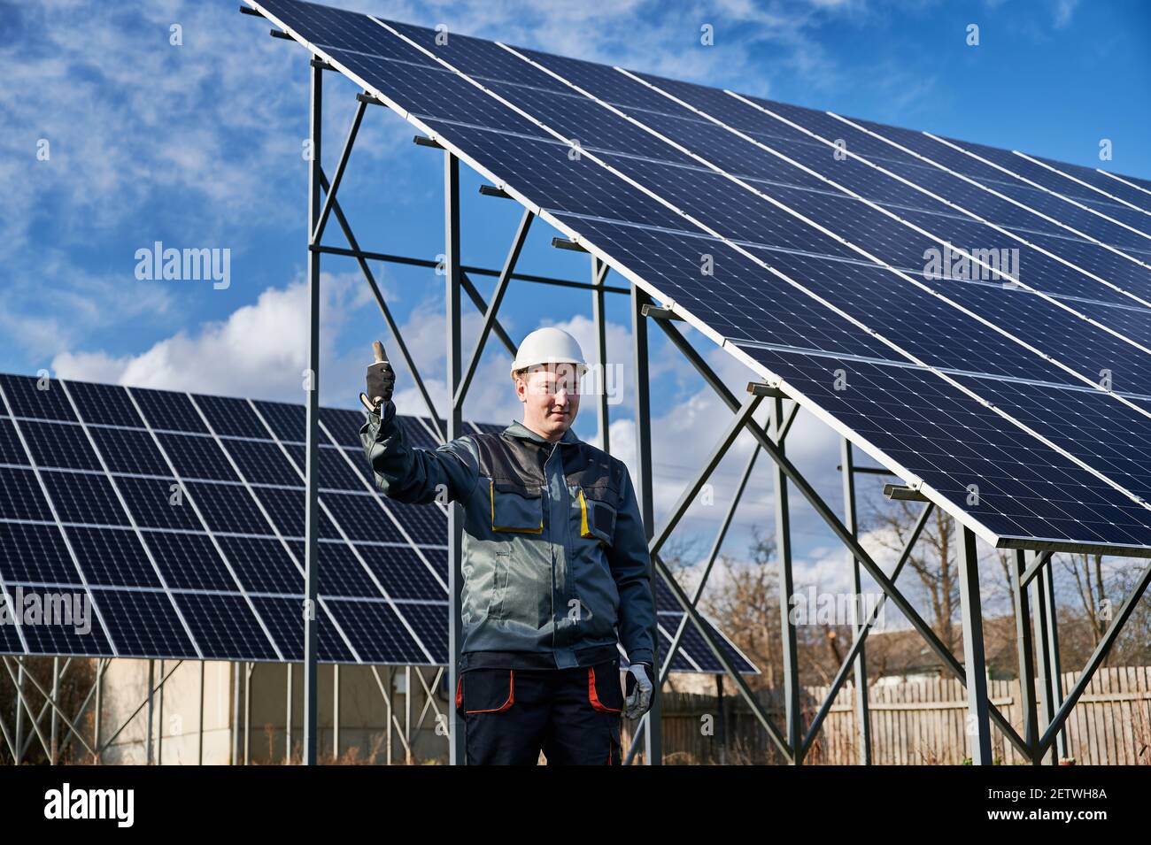 Male technician showing approval gesture thumbs up while standing near ...