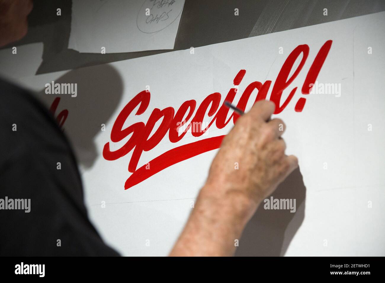 Longtime sign painter Ches Perry paints a restaurant sign May 25, 2017 ...