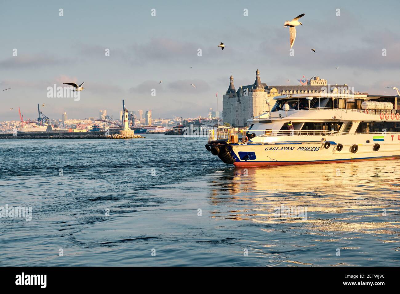 Public transportation by ferry in bosporus with ancient train station ...