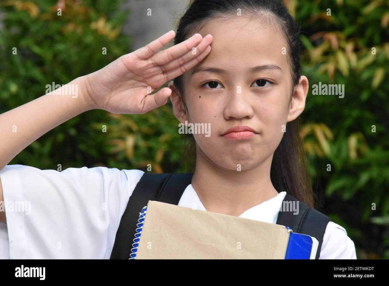 A Cute Girl Student Saluting Stock Photo - Alamy