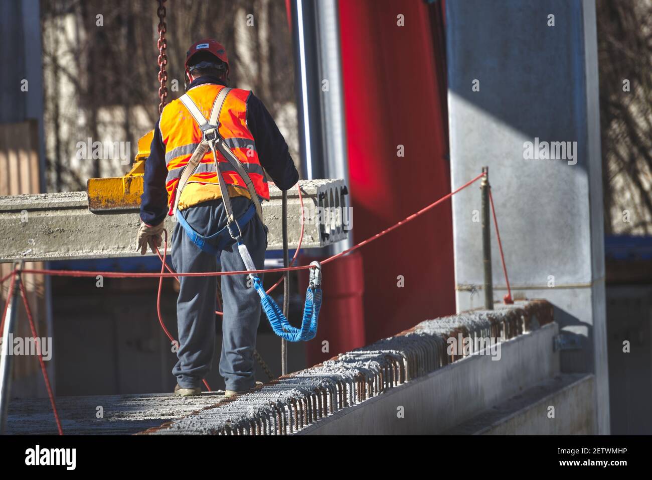 Worker on construction site with work safety system Stock Photo - Alamy