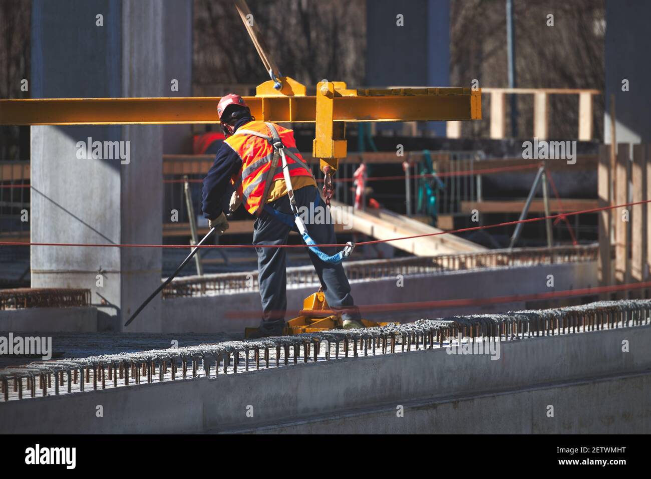 Construction site worker with safety harness hook Stock Photo - Alamy