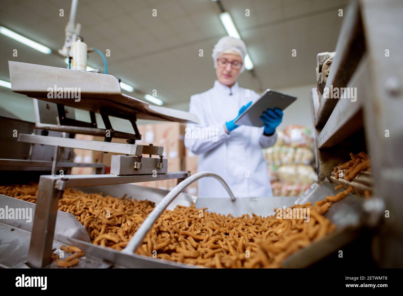 Close up view of a salt stick snacks being processed through a ...
