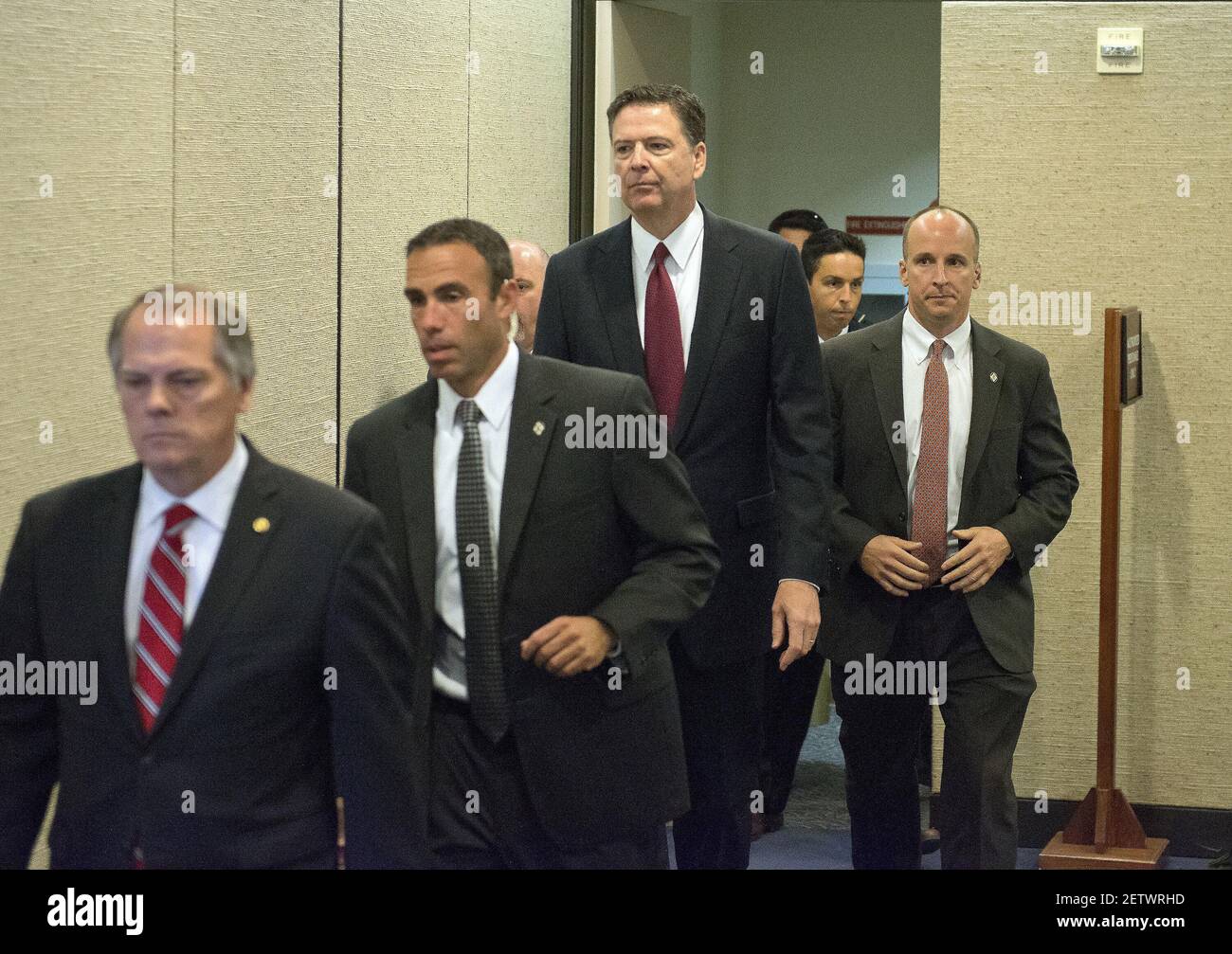 Former FBI Director James Comey walks to the closed portion of his ...
