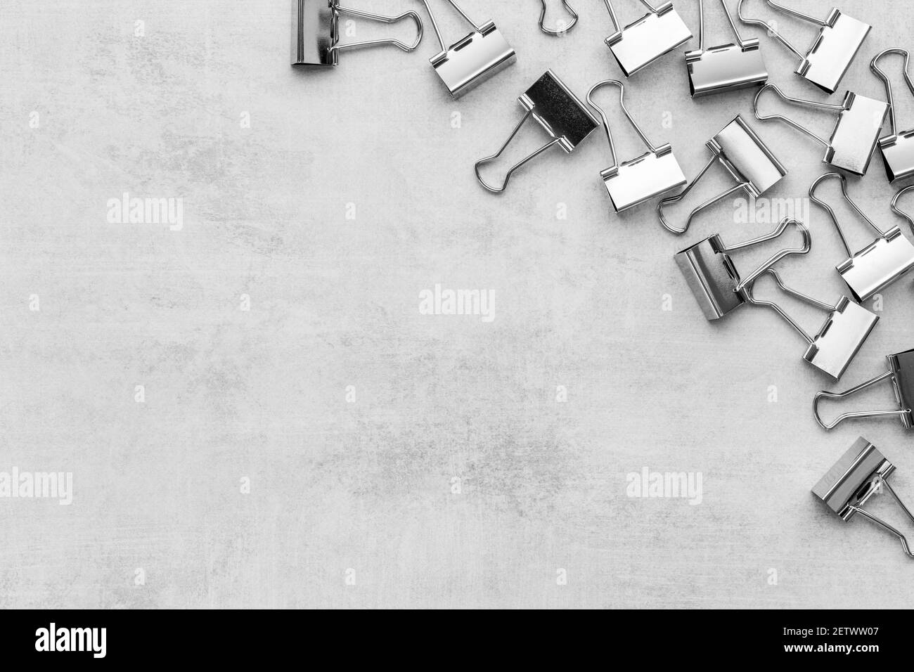 Stationery and office supplies background. Paper binder clips top view ...