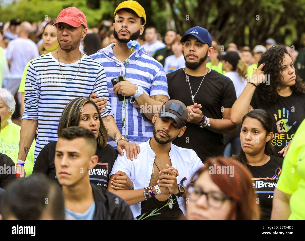 Pulse survivor Angel Colon, seated center, sits with family and friends ...