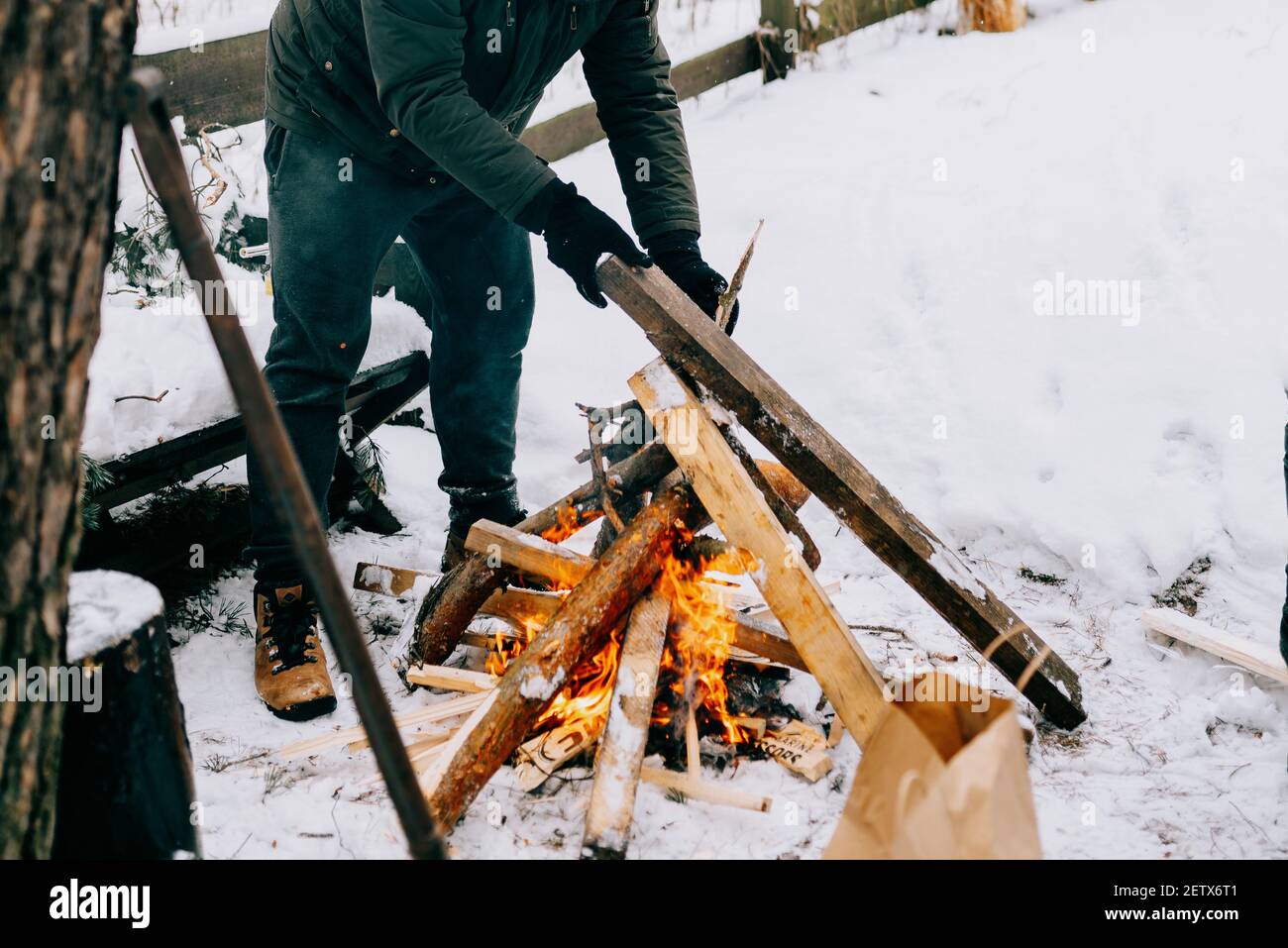 Lighting a fire in the forest in winter Stock Photo - Alamy