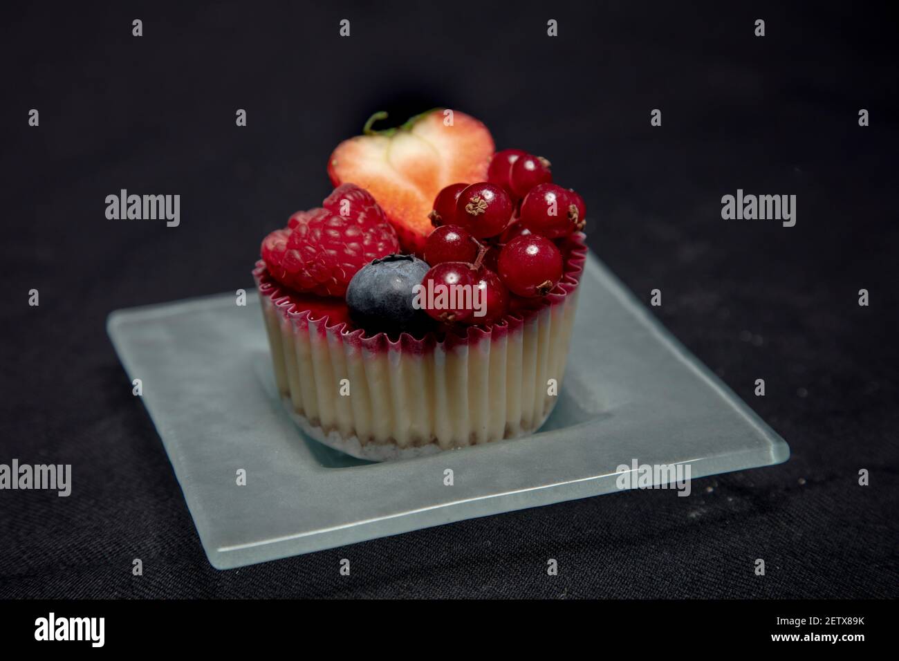 beautiful and tasty looking cheesecake on a black background, front ...