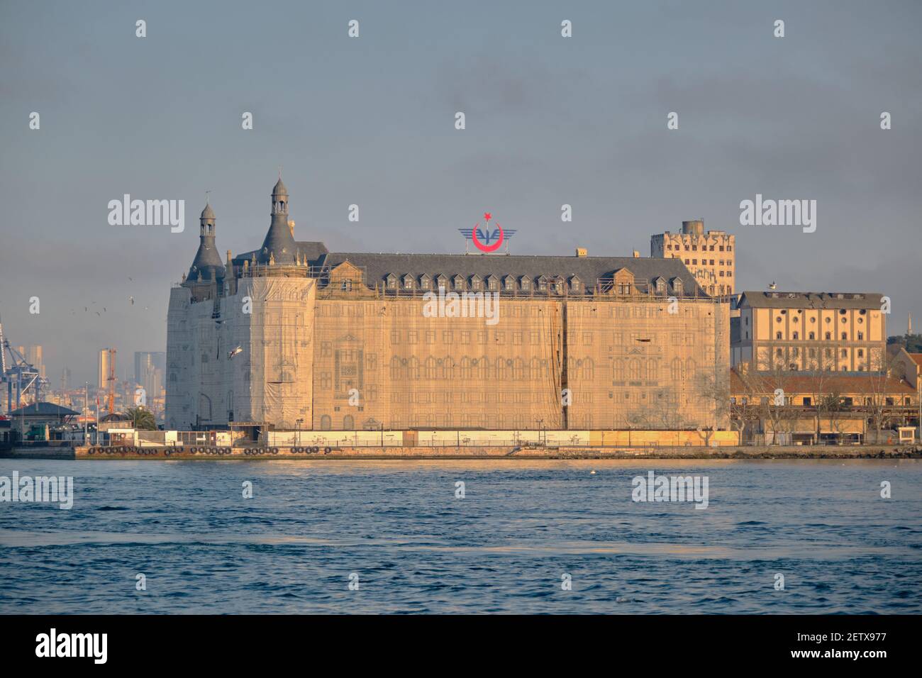 Many birds and seagulls in bosporus with old and ancient train station ...
