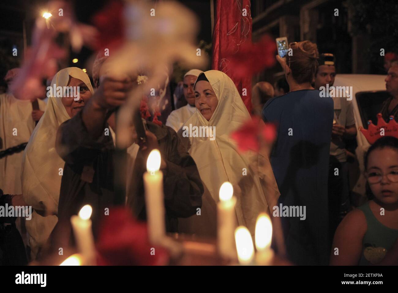 Women dressed in a large white scarf (Sefsari in Arabic), which is a ...
