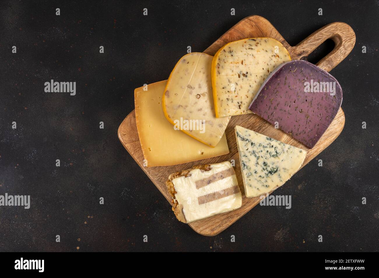 Various types of exclusive cheeses on dark background. Top view Stock ...