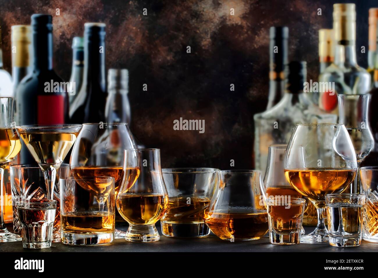 Hard strong alcoholic drinks and distillates in glasses and bottles in ...
