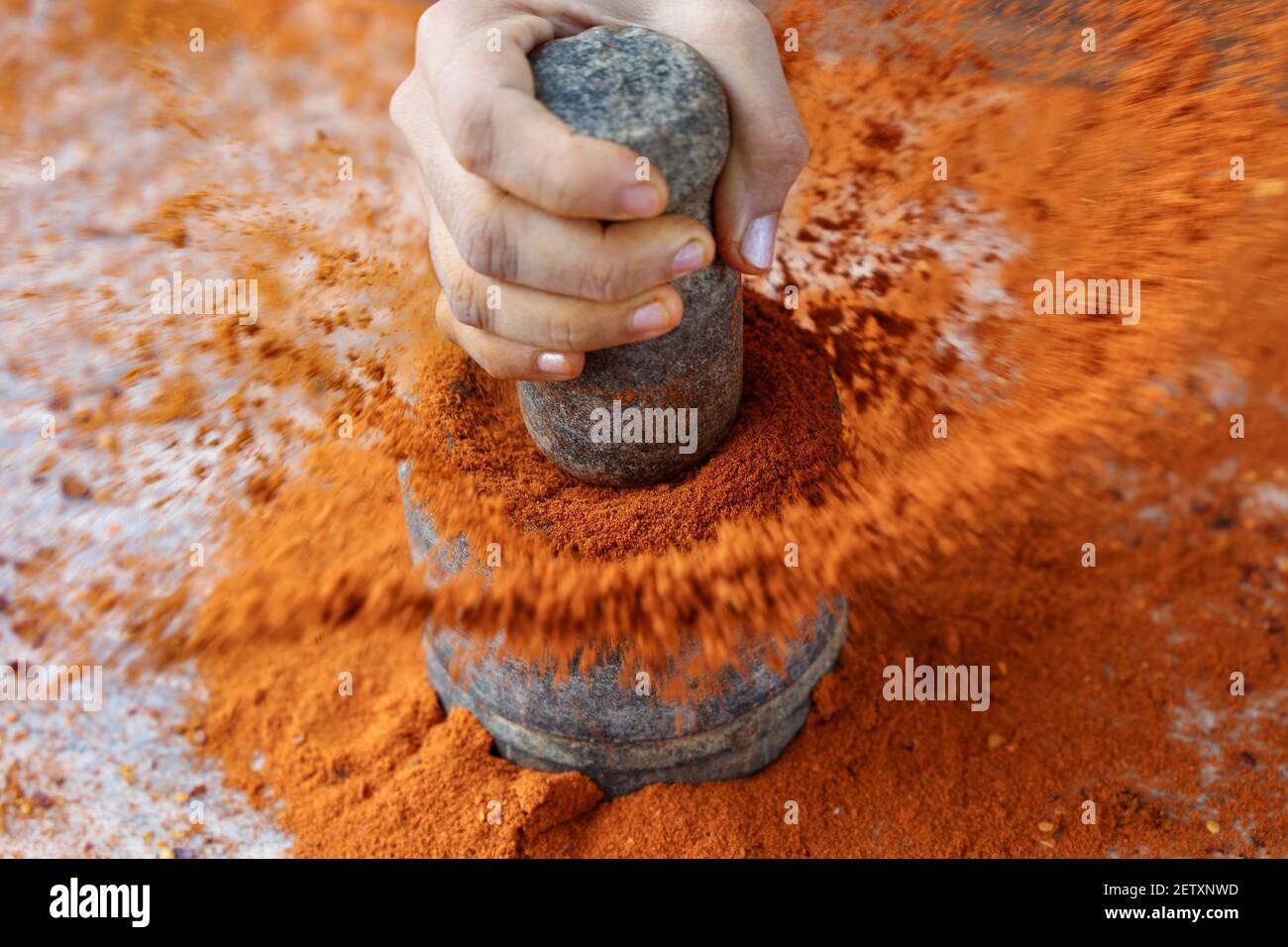 Indian woman hand powdering Indian spices Red chilly , chili paprika ...