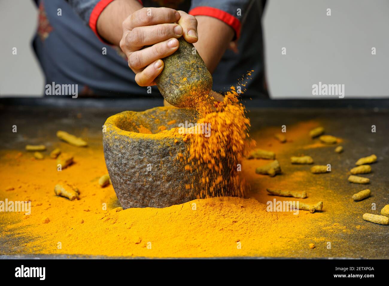 Woman hand powdering Indian spices turmeric powder splash explosion ...