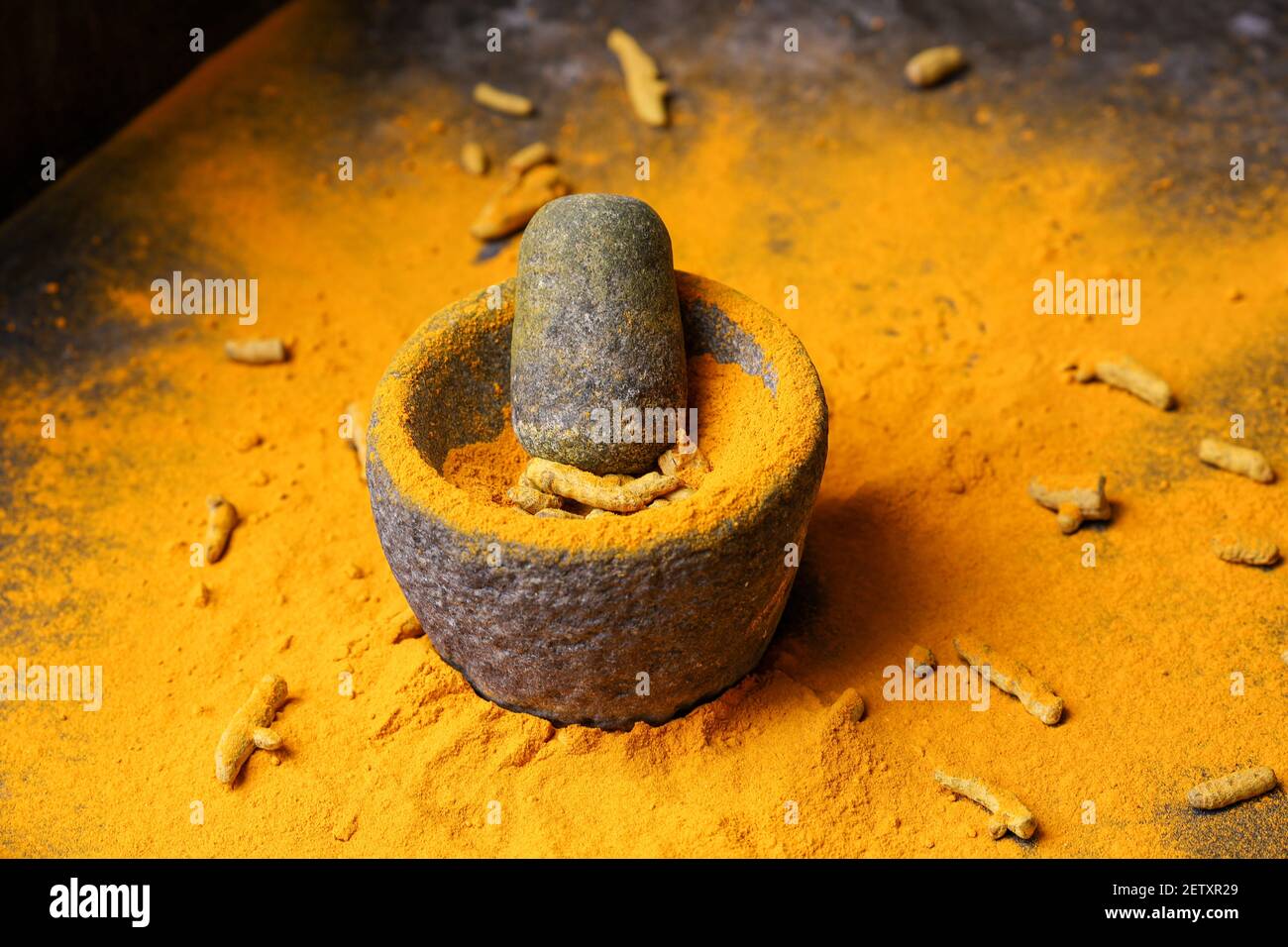 Woman hand powdering Indian spices turmeric powder splash explosion ...