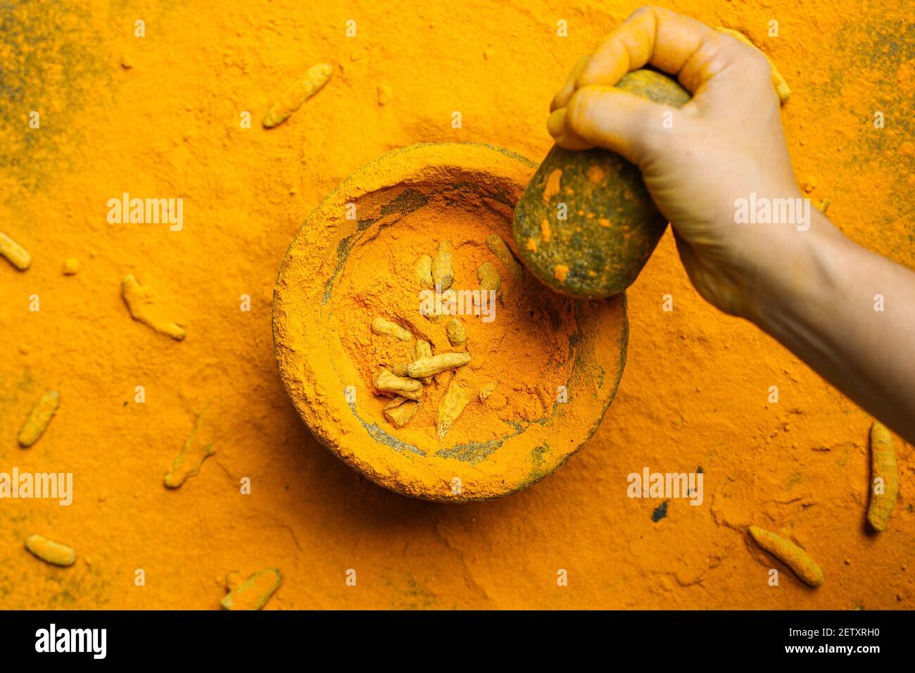 Woman hand powdering Indian spices turmeric powder splash explosion ...