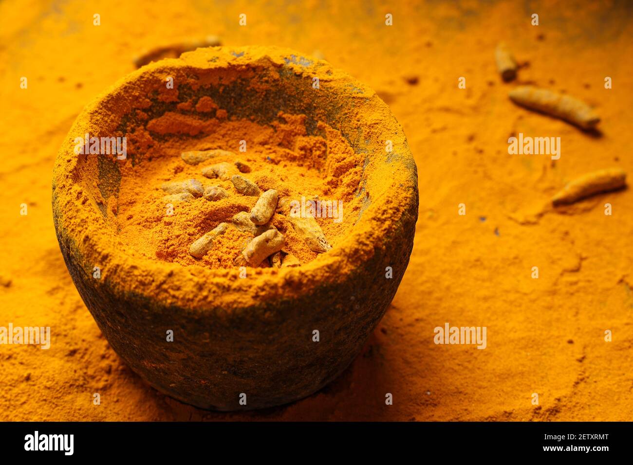 Woman hand powdering Indian spices turmeric powder splash explosion ...
