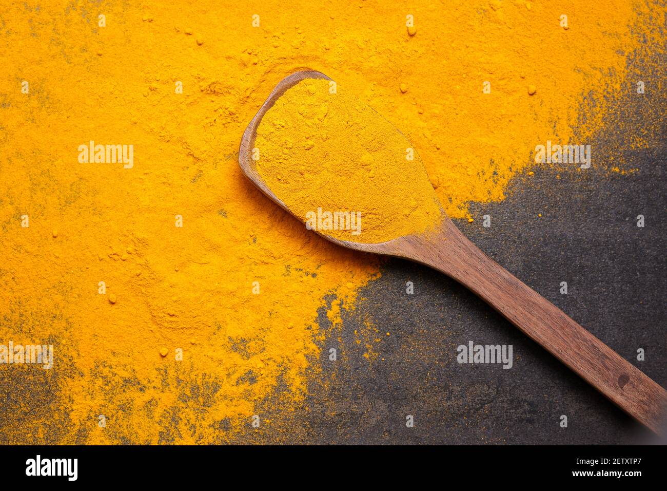 Woman hand powdering Indian spices turmeric powder splash explosion ...