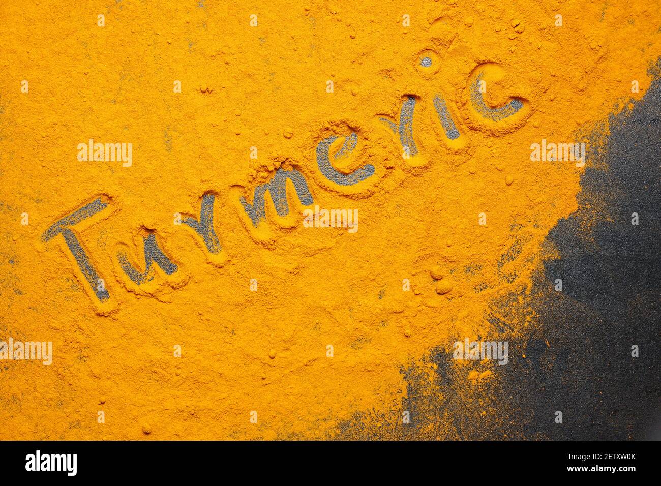 Woman hand powdering Indian spices turmeric powder splash explosion ...