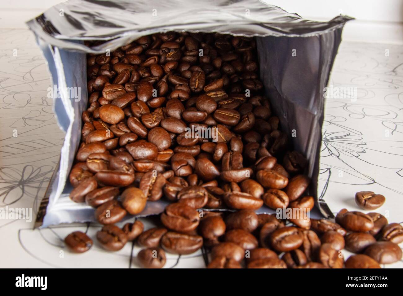Open pack of medium-roasted coffee beans Stock Photo - Alamy