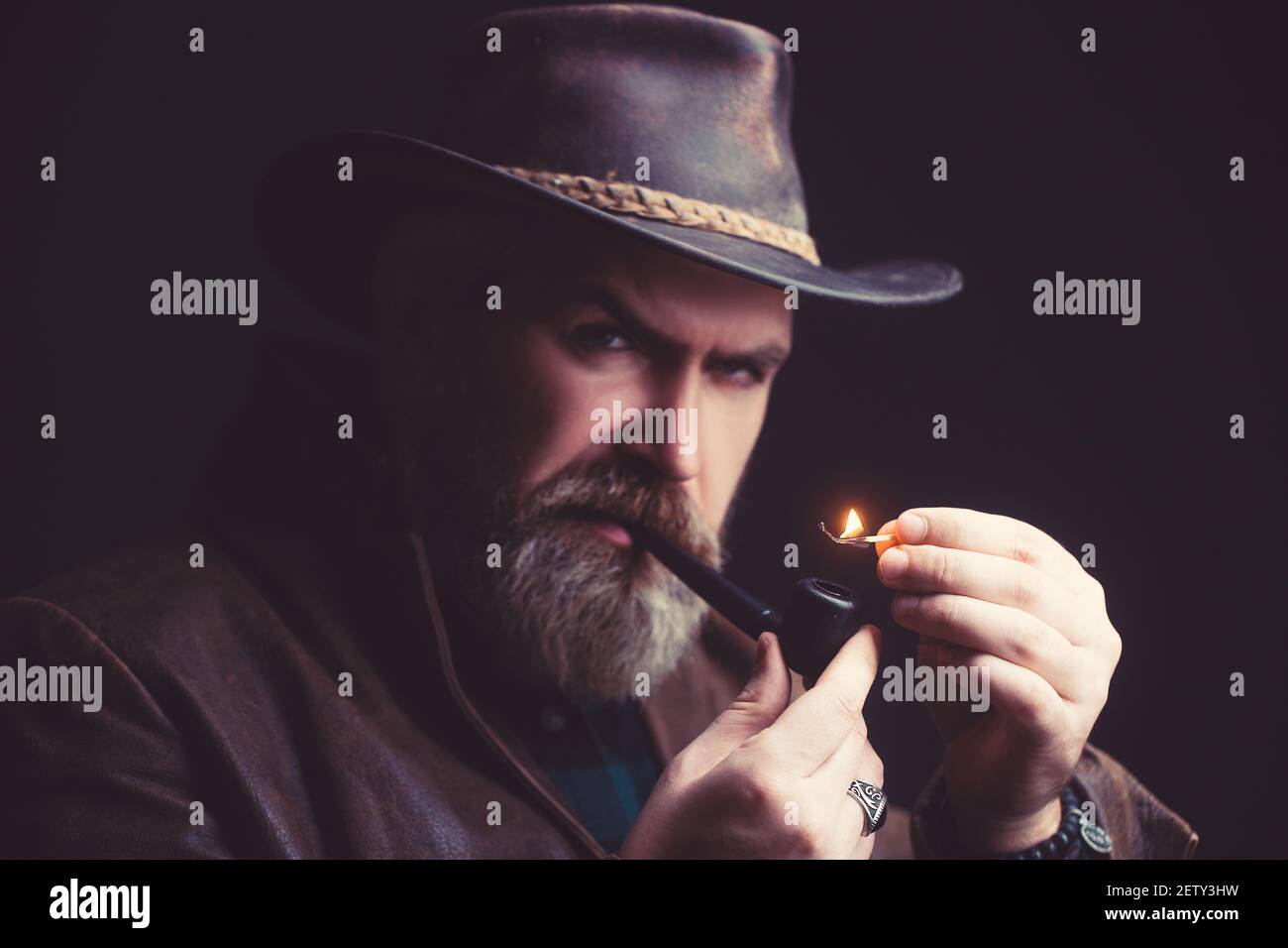 Bearded man smoking tradition pipe. Fashion portrait Stock Photo - Alamy